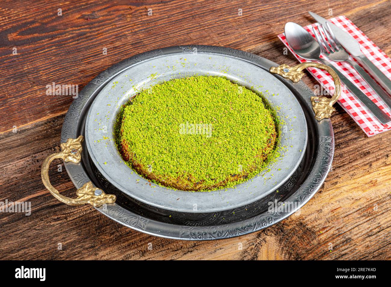Turkish dessert kunefe, kunafa, kadayif with pistachio powder and ...