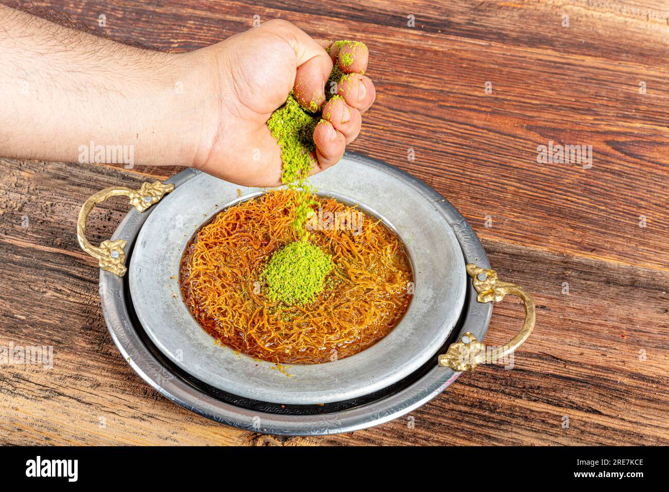 Turkish dessert kunefe, kunafa, kadayif with pistachio powder and ...