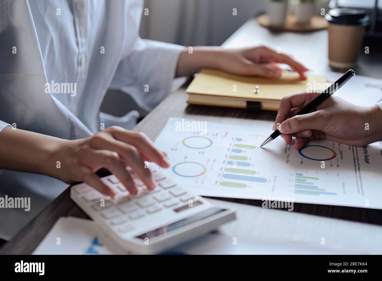 Teamwork of business people discuss and use calculator for finance ...