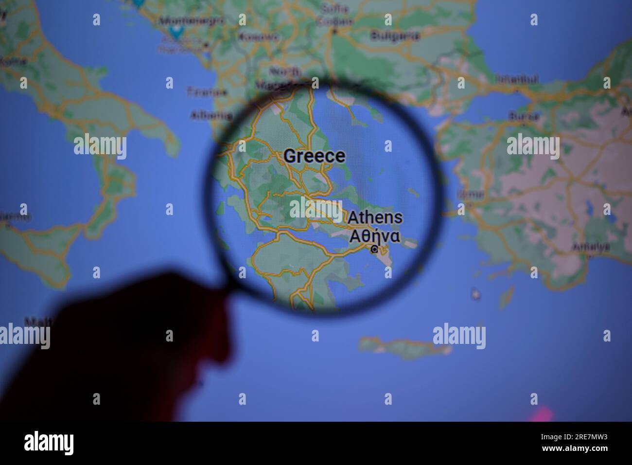 Greece trough magnifying glass on map Stock Photo - Alamy