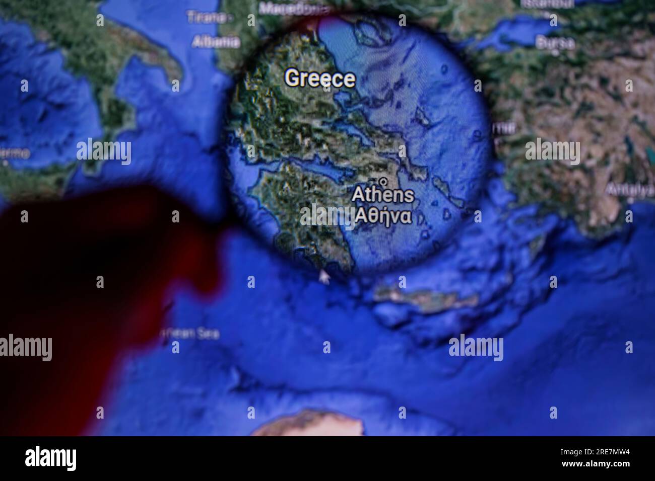 Greece trough magnifying glass on map Stock Photo - Alamy