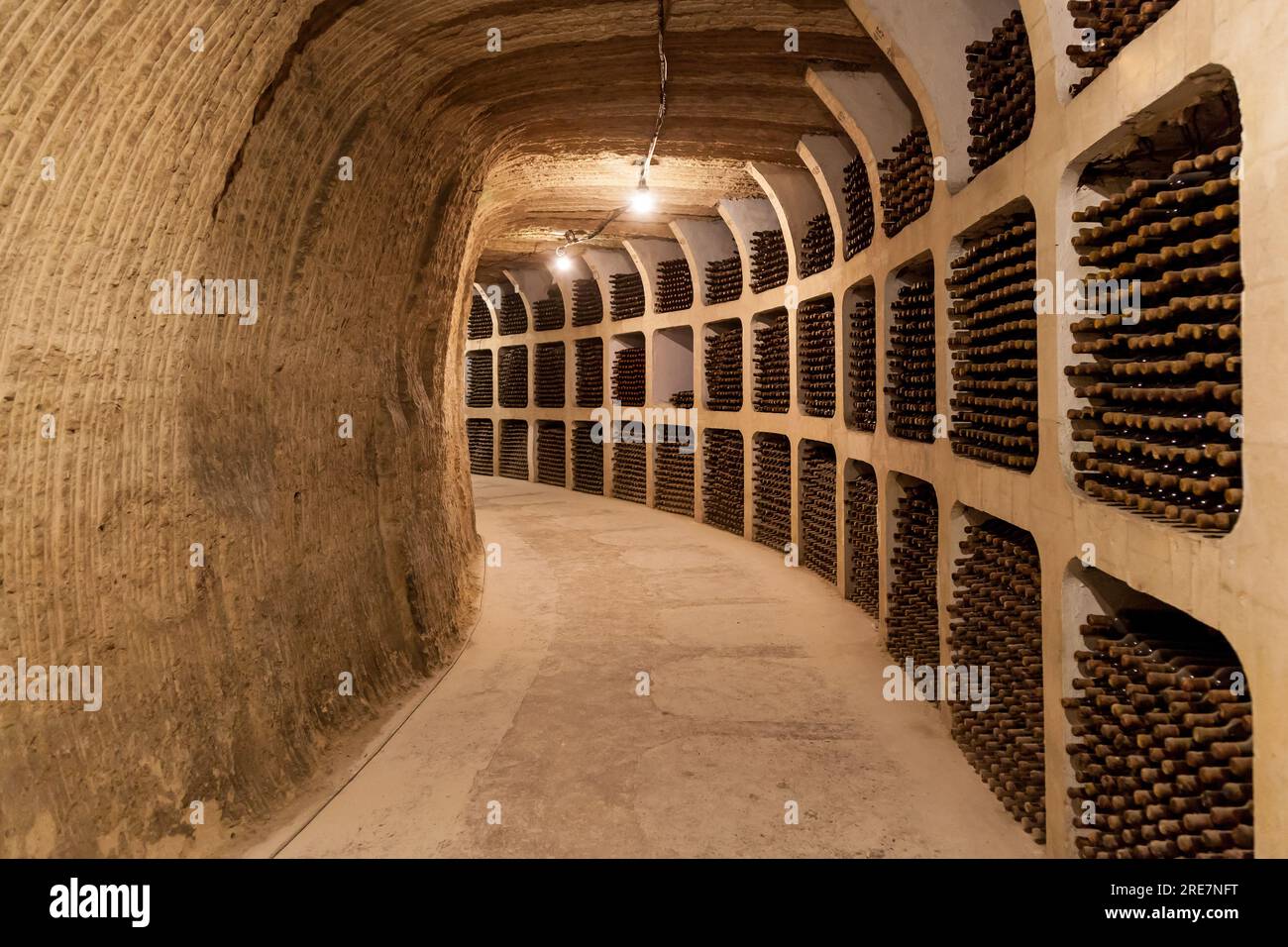 Old wine cellar with stacks of old wine bottles.Old wine bottles are ...