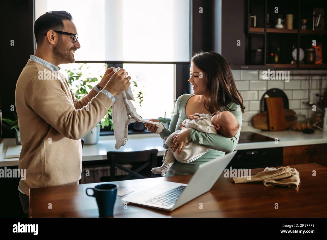 Online shopping. Young family with infant child purchasing things on ...