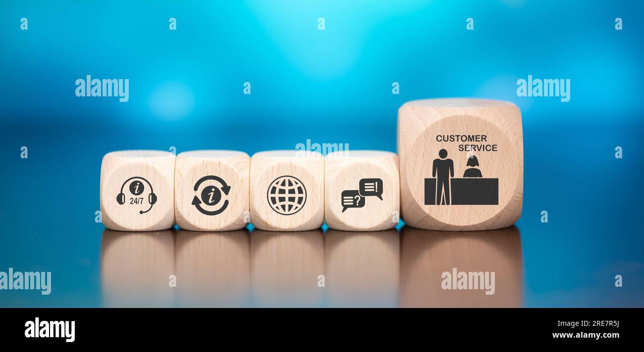 Wooden blocks with symbol of customer service concept on blue ...
