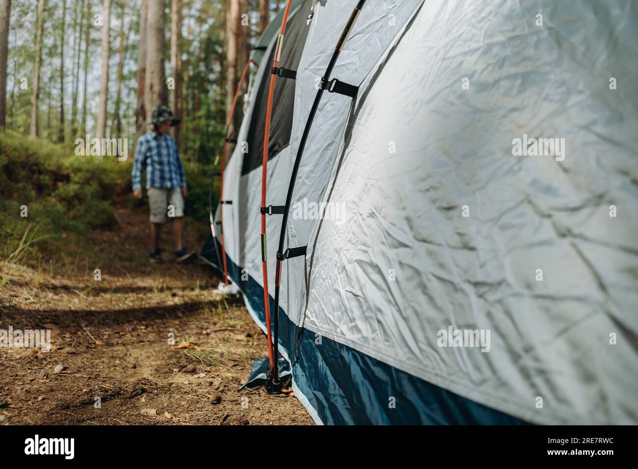 cute caucasian boy putting up a tent. Family camping concept Stock Photo - Alamy