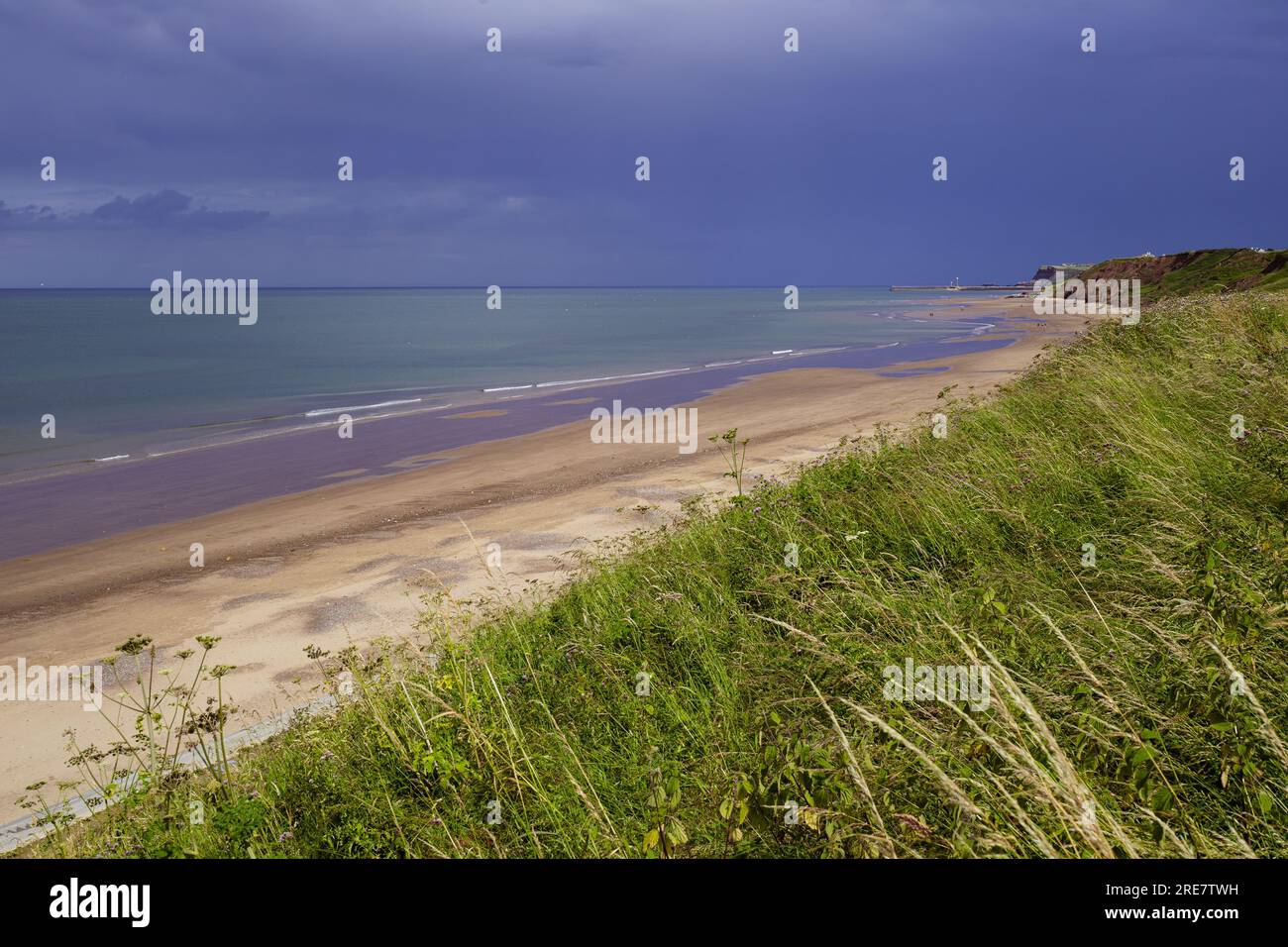 Clifftop view of the sandy beach that leads to the small village of ...