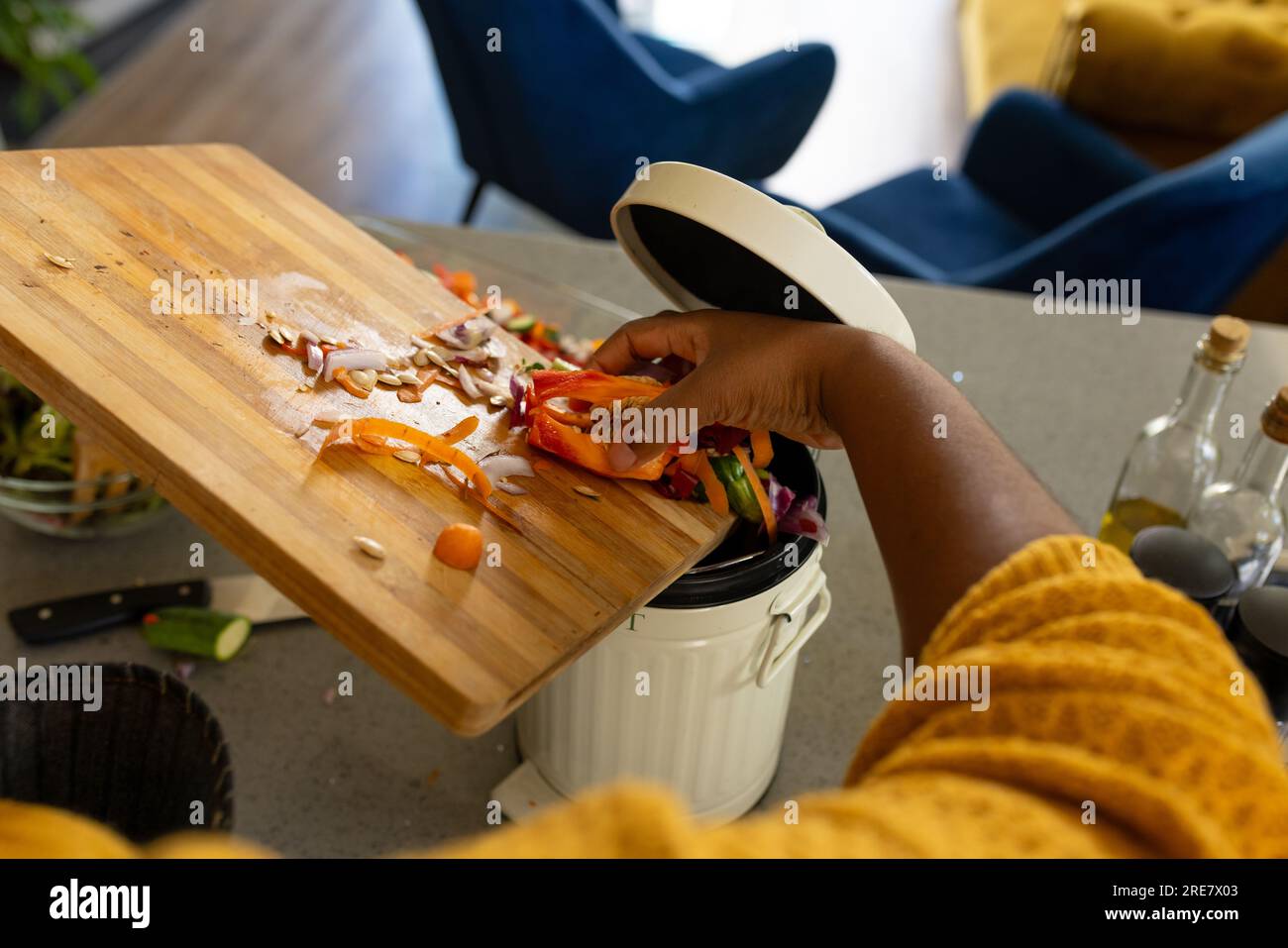 Hand of plus size african american woman in apron composting vegetable ...