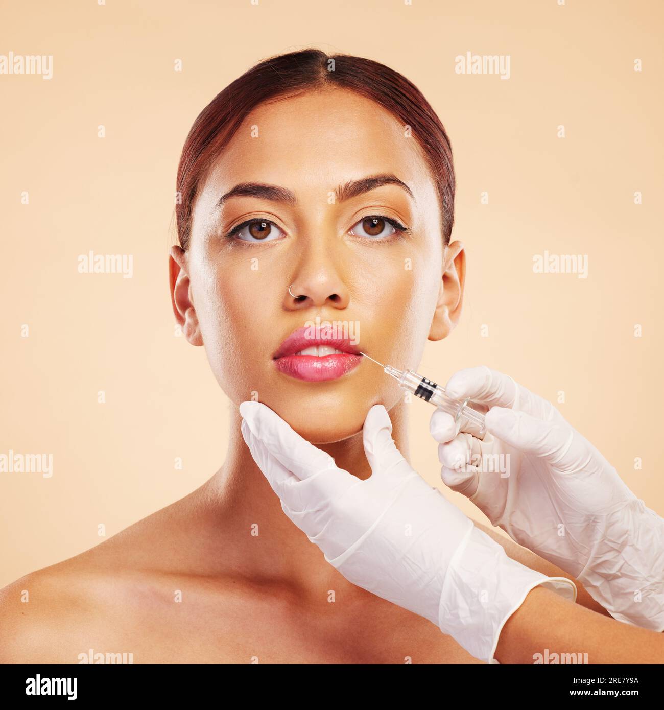 Portrait, woman or plastic surgery with a needle, lip filler and cosmetics isolated on studio ...