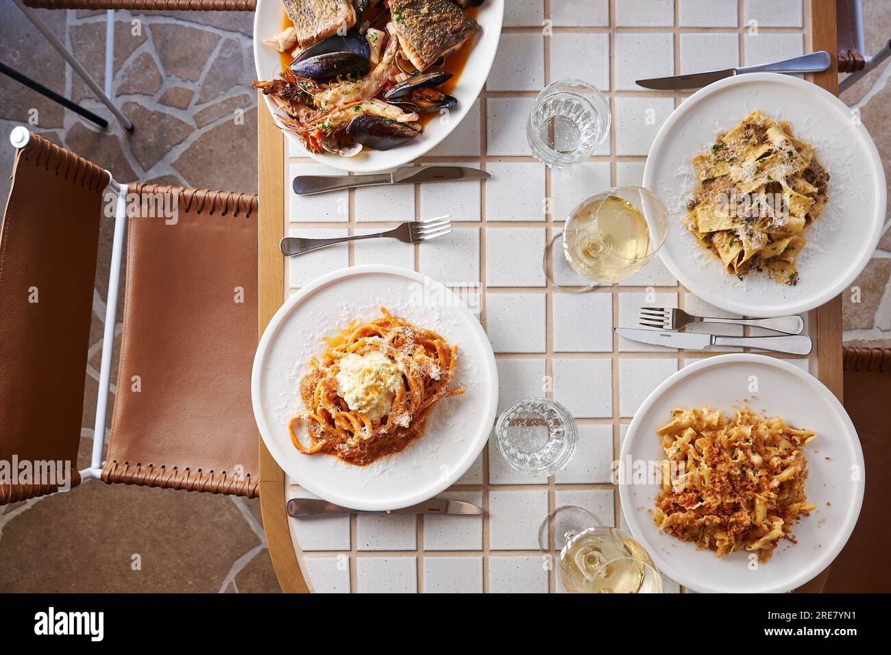 Italian feast with different dishes at restaurant Stock Photo - Alamy