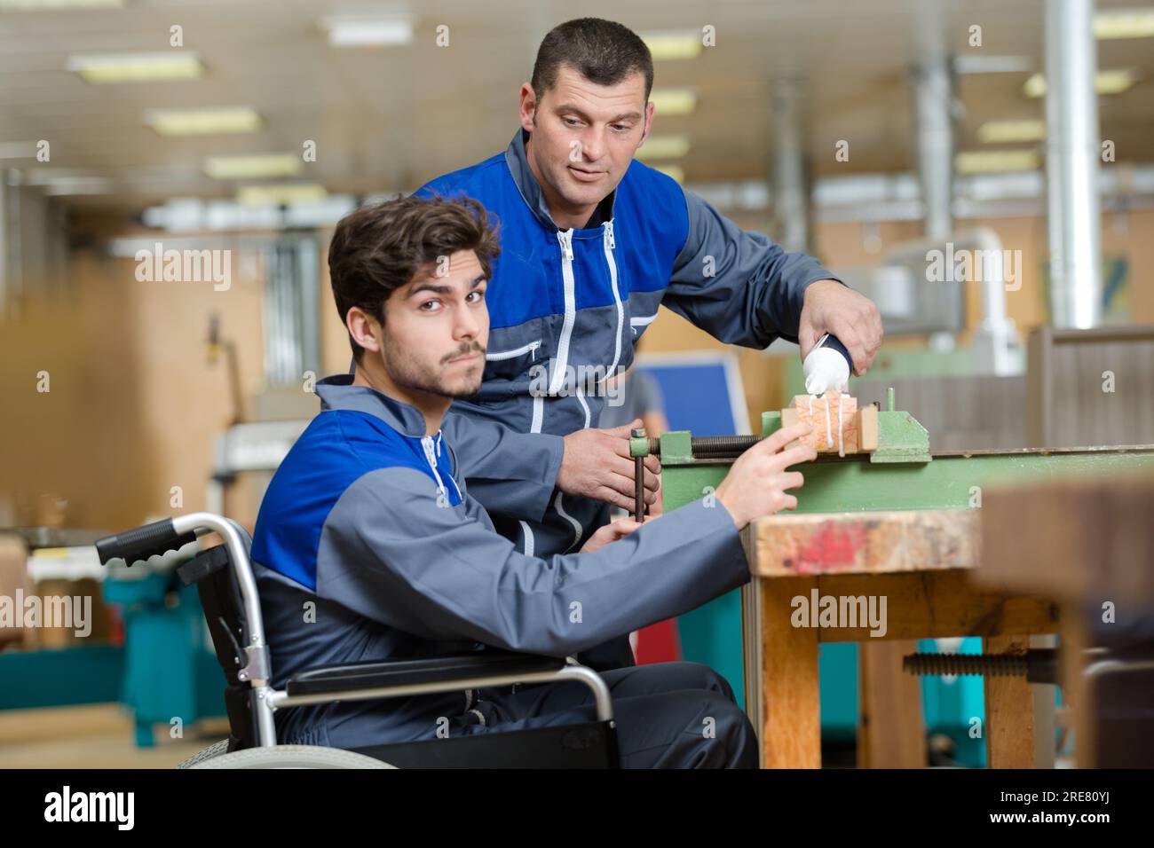 disabled worker in wheelchair in factory on the machine Stock Photo - Alamy