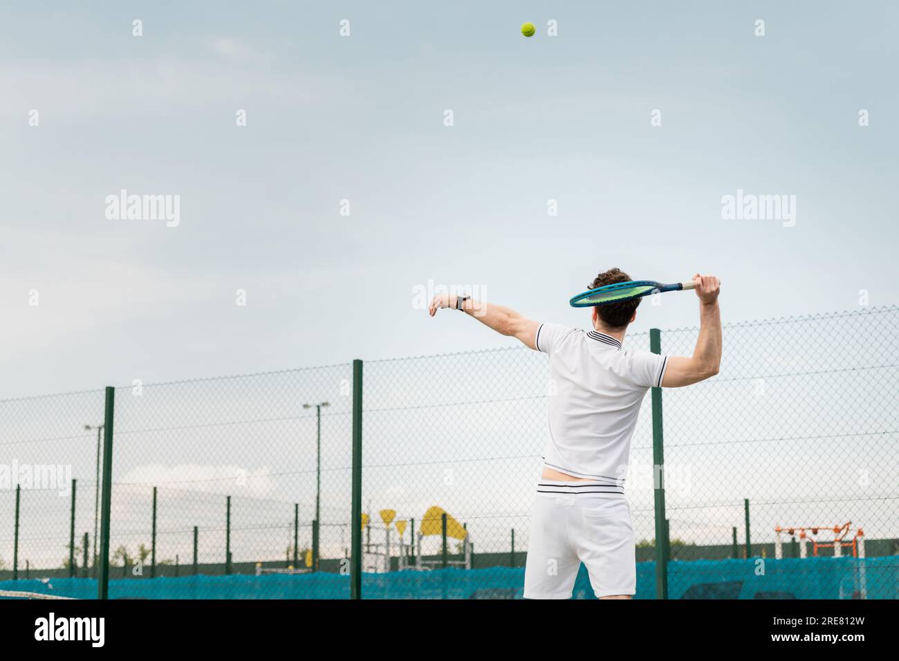 backhand, man in active wear playing tennis, holding racket, hitting ...