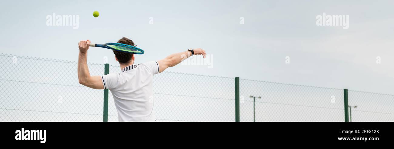 banner, backhand, man playing tennis on court, holding racket, hitting ...