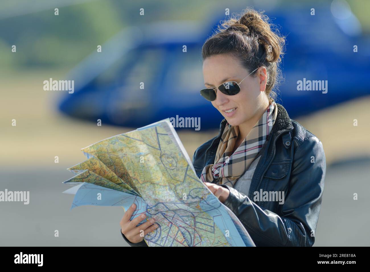 female helicopter pilot studying map Stock Photo - Alamy