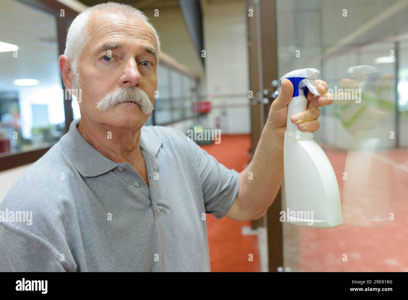 senior man cleaning window glass Stock Photo - Alamy