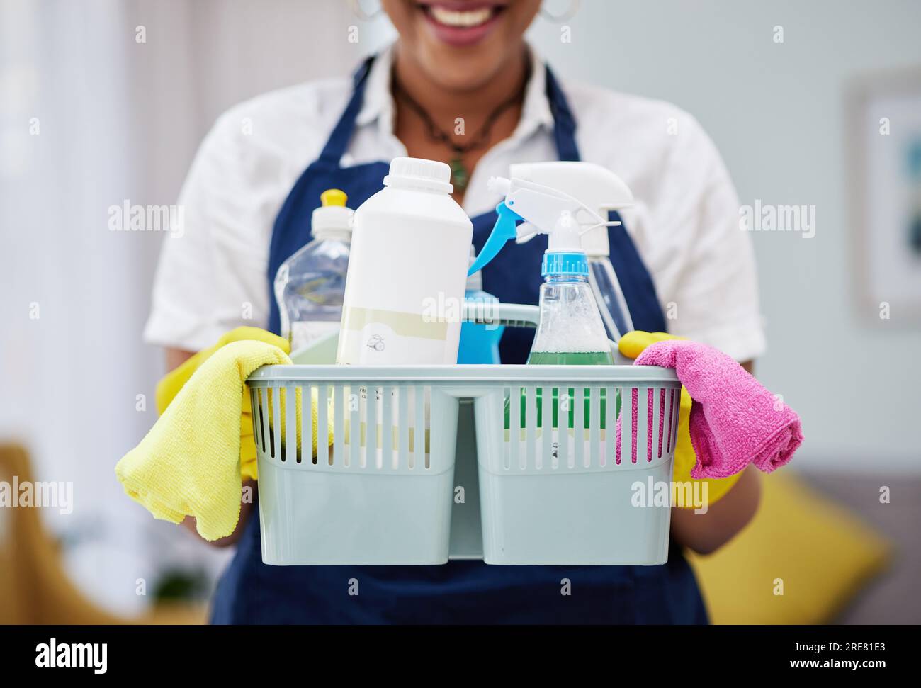 Cleaning, chemical and basket with hands of woman in living room for ...
