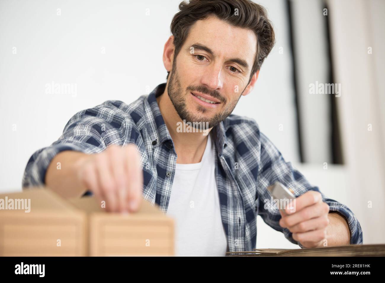 happy male worker making boxes Stock Photo - Alamy