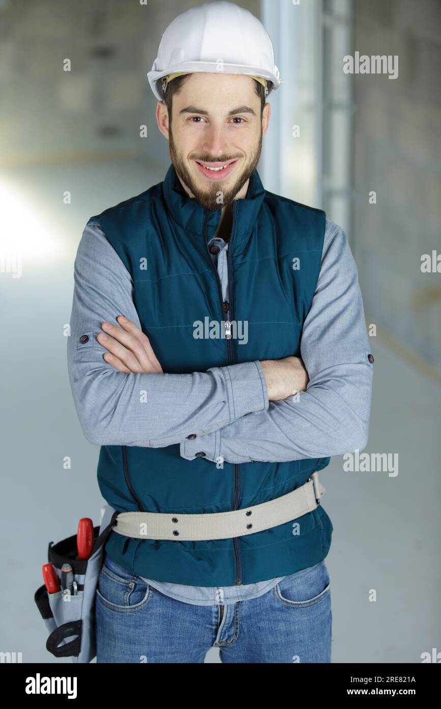 authentic construction worker smiling with arms crossed Stock Photo - Alamy