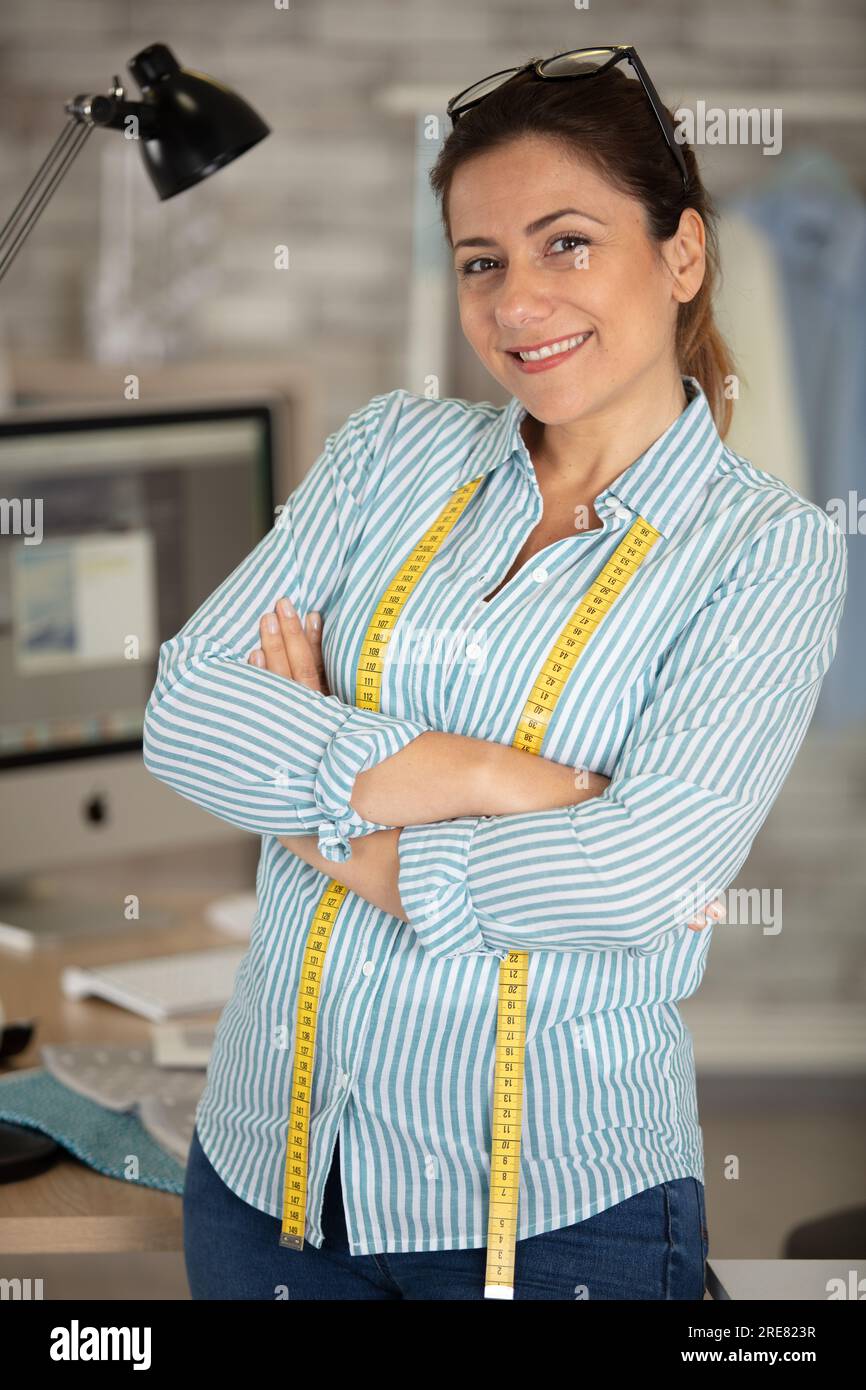 fashion designer standing at workplace in studio Stock Photo - Alamy