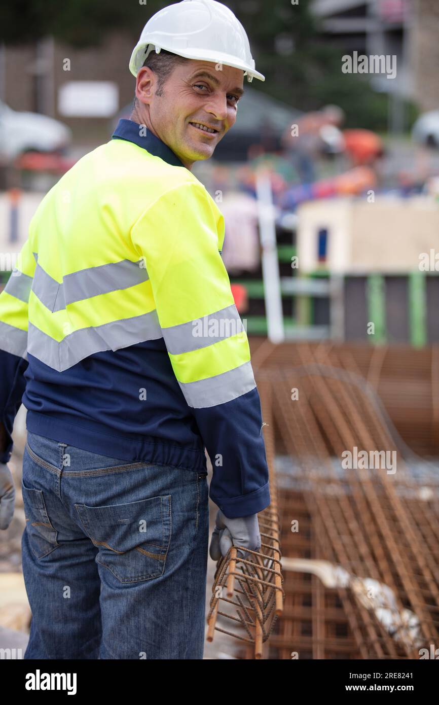 builder worker in safety protective equipment at construction site ...