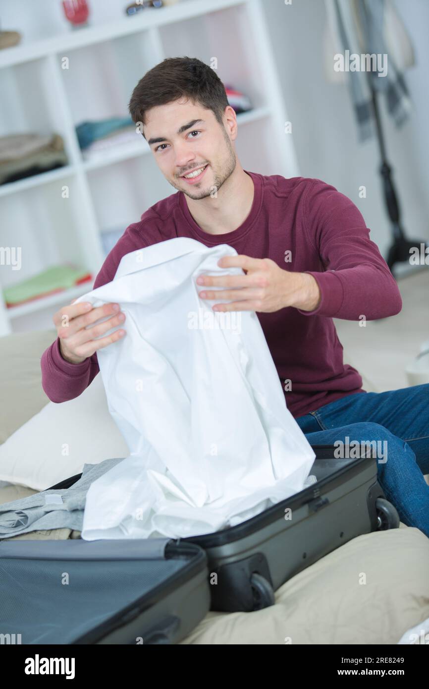businessman packing things in suitcase Stock Photo - Alamy