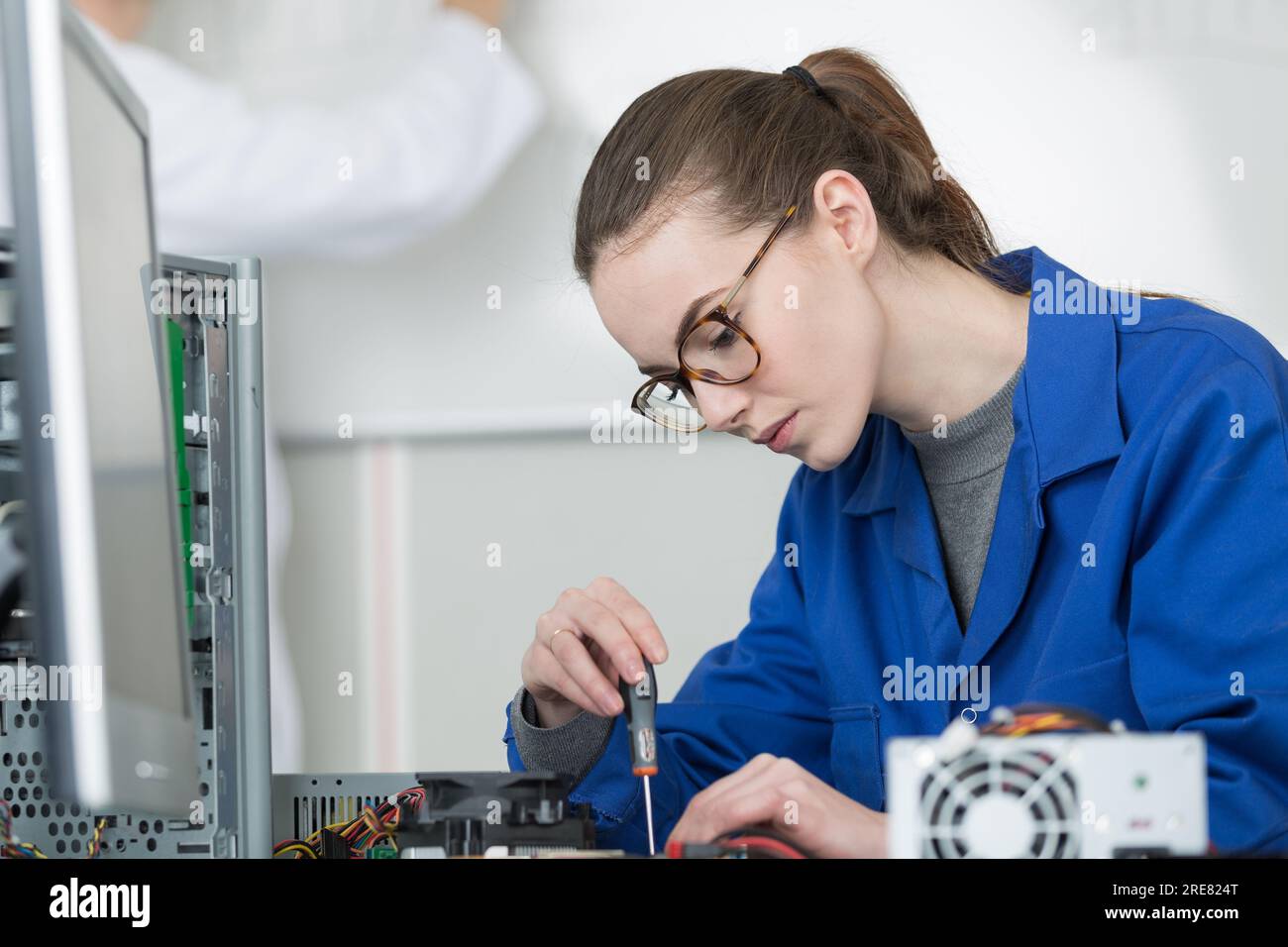 female computer engineer repairing computer motherboard Stock Photo - Alamy