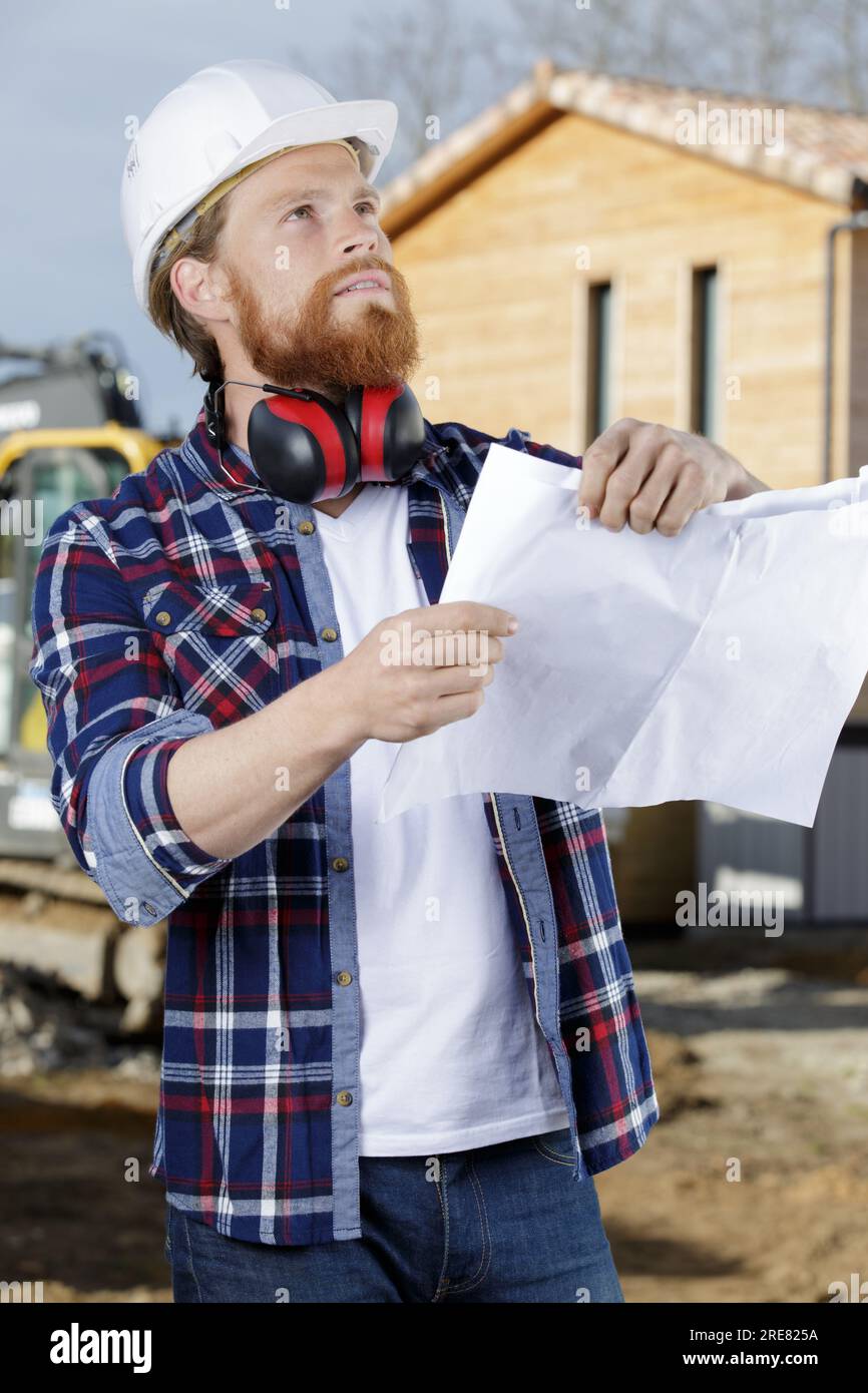 engineer standing with builder outdoors Stock Photo - Alamy