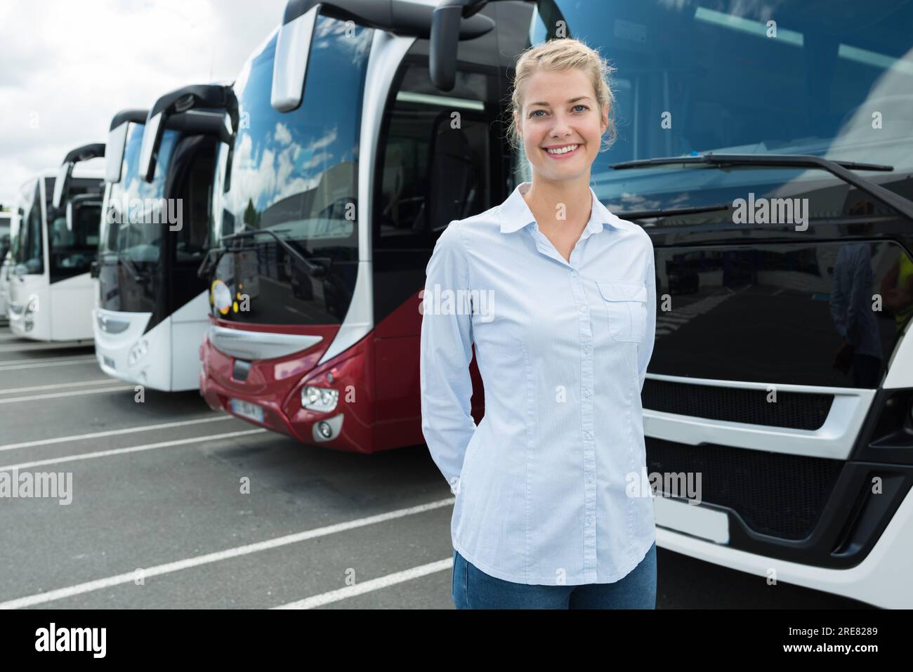 female bus operator posing in front of buses Stock Photo - Alamy