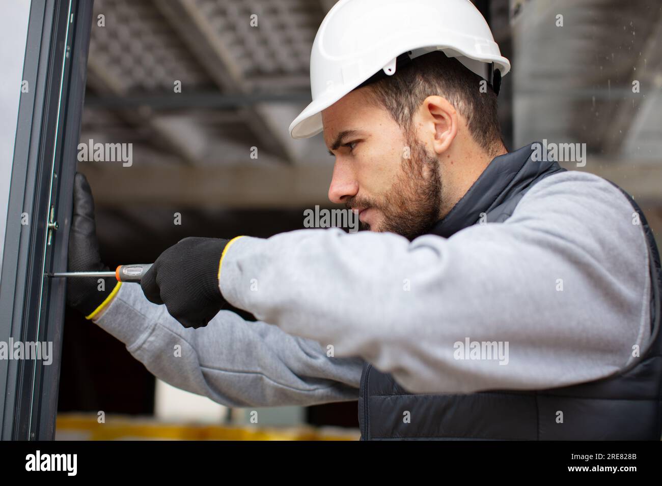 construction worker installing window in house Stock Photo - Alamy