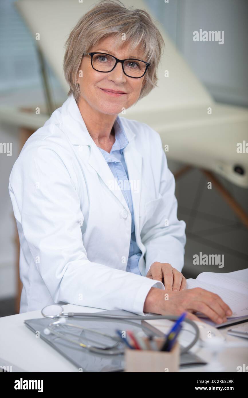 Smiling attractive mature female doctor hi-res stock photography and ...