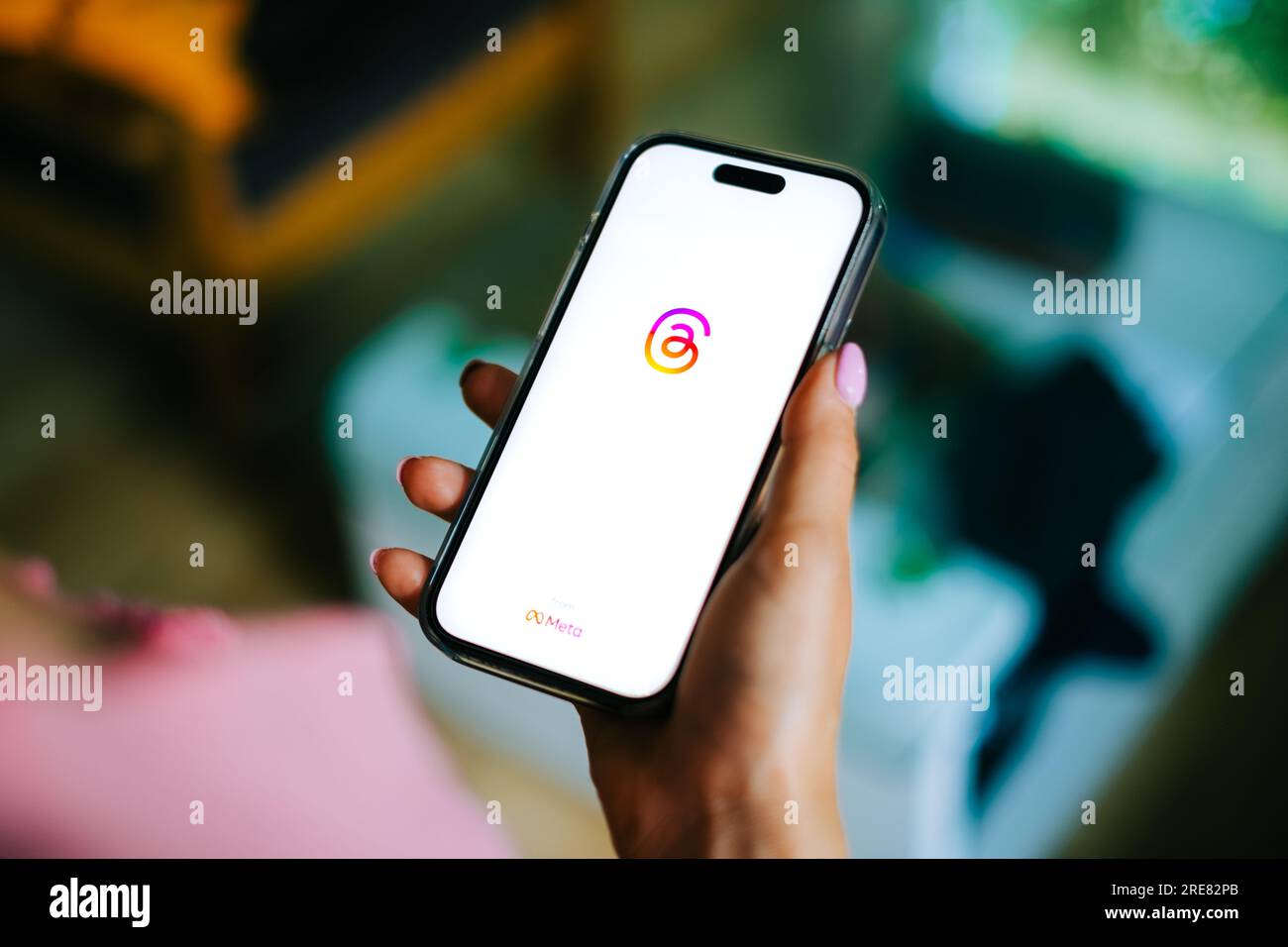 Threads app logo on iPhone screen in hands Stock Photo - Alamy