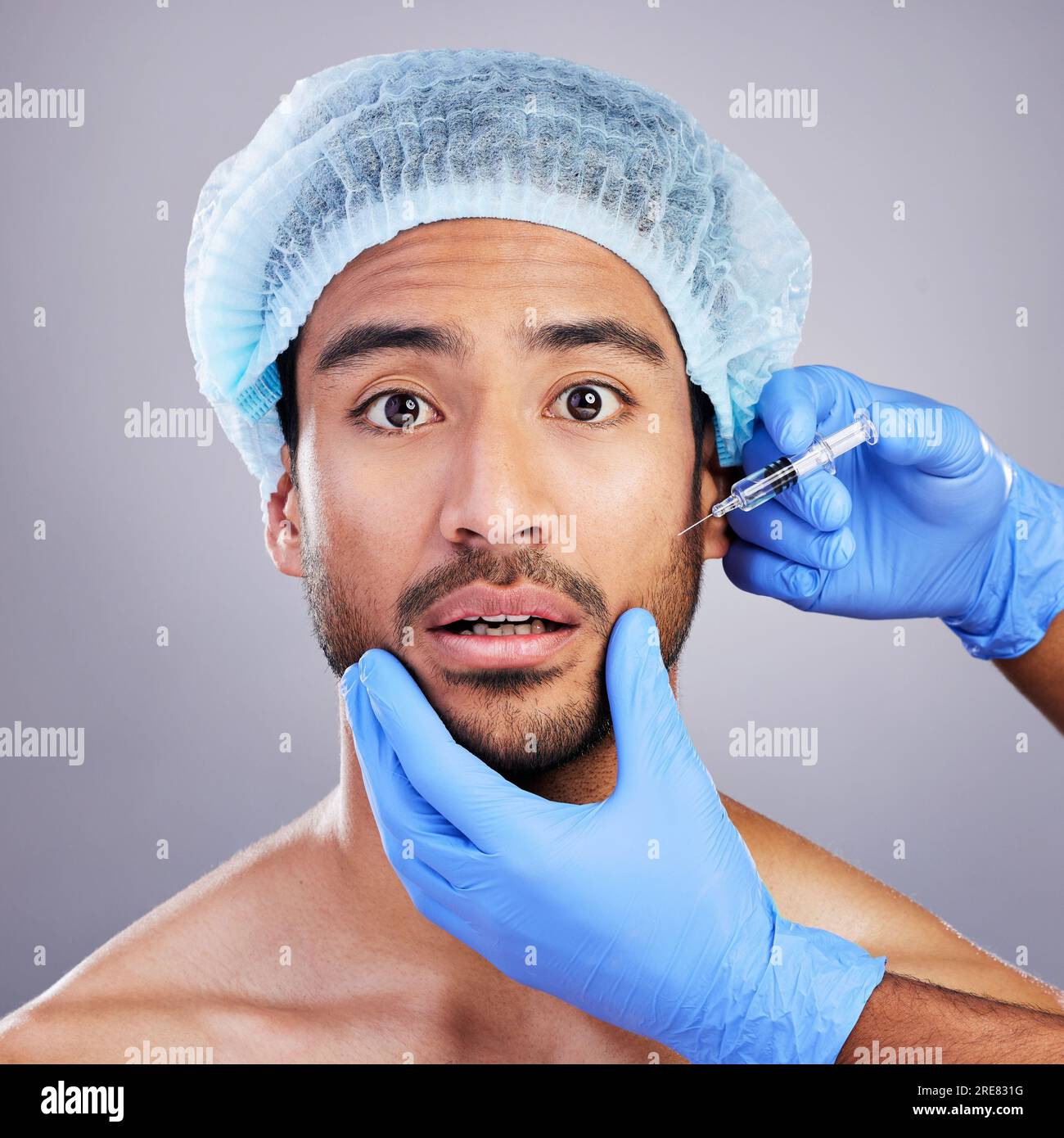 Hands, portrait and plastic surgery with a man in studio on a gray ...