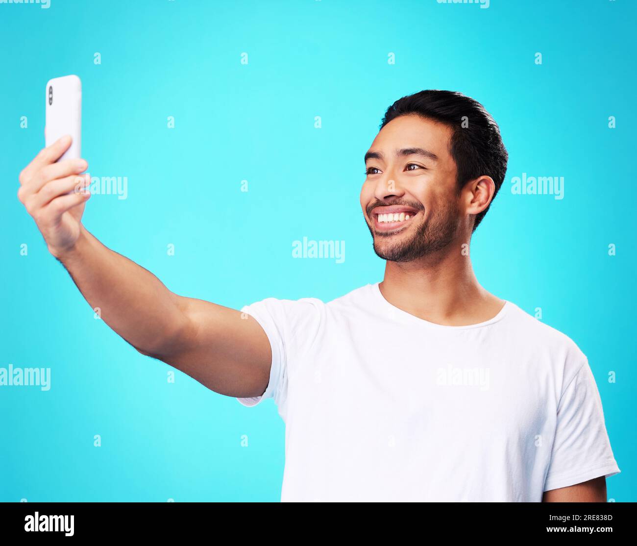Asian man, selfie and smile in studio for social media post, web chat ...
