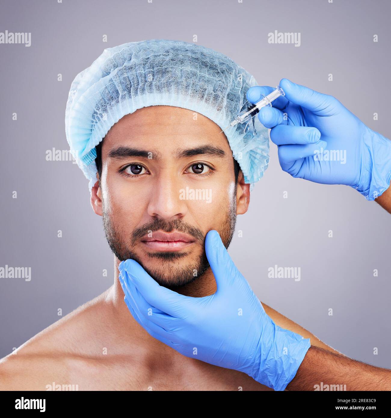 Hands, portrait and transformation with a man in studio on a gray ...