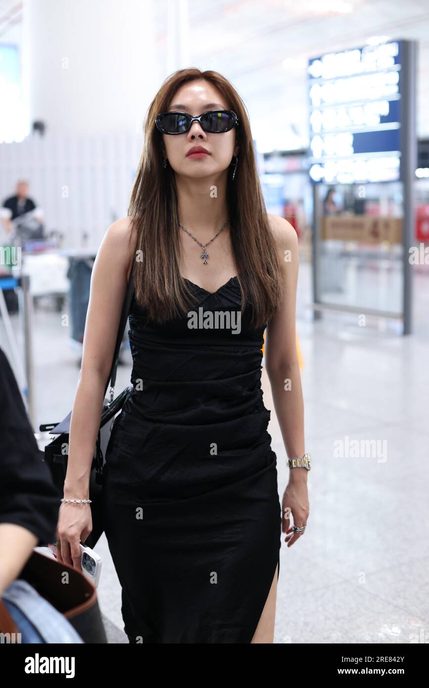 Chinese singer and actress Fei appears at airport in Beijing, China ...