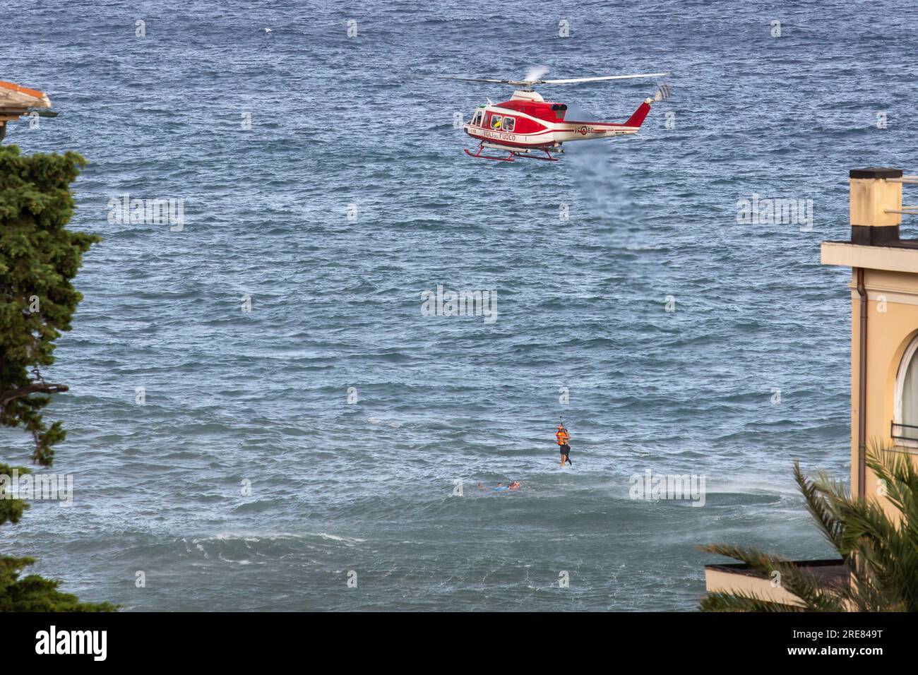 Helicopter rescue swimmers of Vigili del Fuoco assist a group of ...