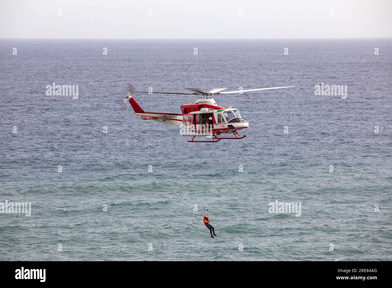 Helicopter rescue swimmers of Vigili del Fuoco assist a group of ...