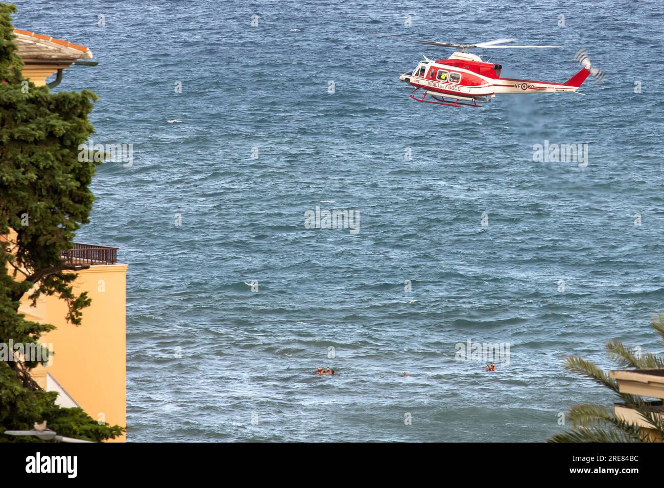 Helicopter rescue swimmers of Vigili del Fuoco assist a group of ...