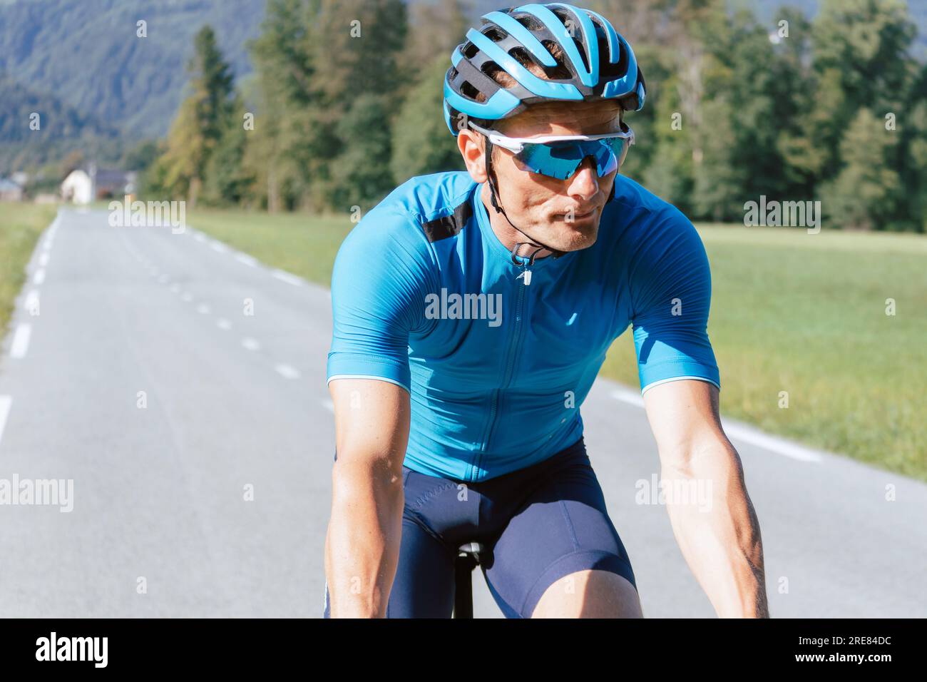 Man road cycling on race bike outdoor in nature Stock Photo - Alamy