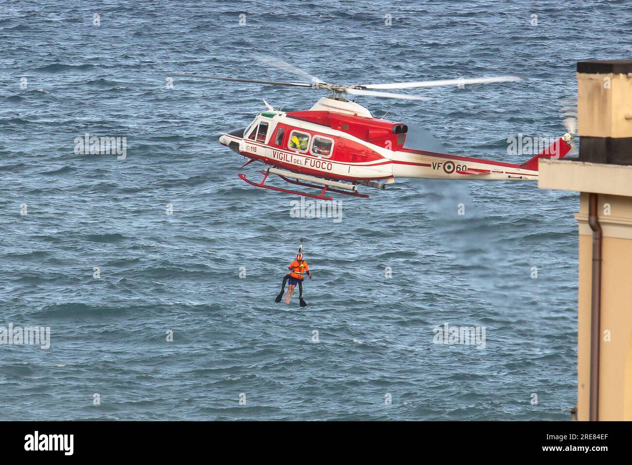 Helicopter rescue swimmers of Vigili del Fuoco assist a group of ...