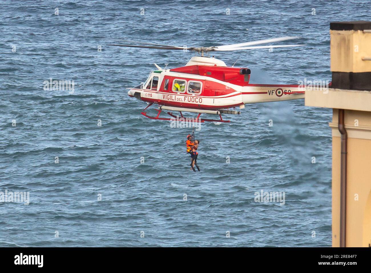 Helicopter rescue swimmers of Vigili del Fuoco assist a group of ...