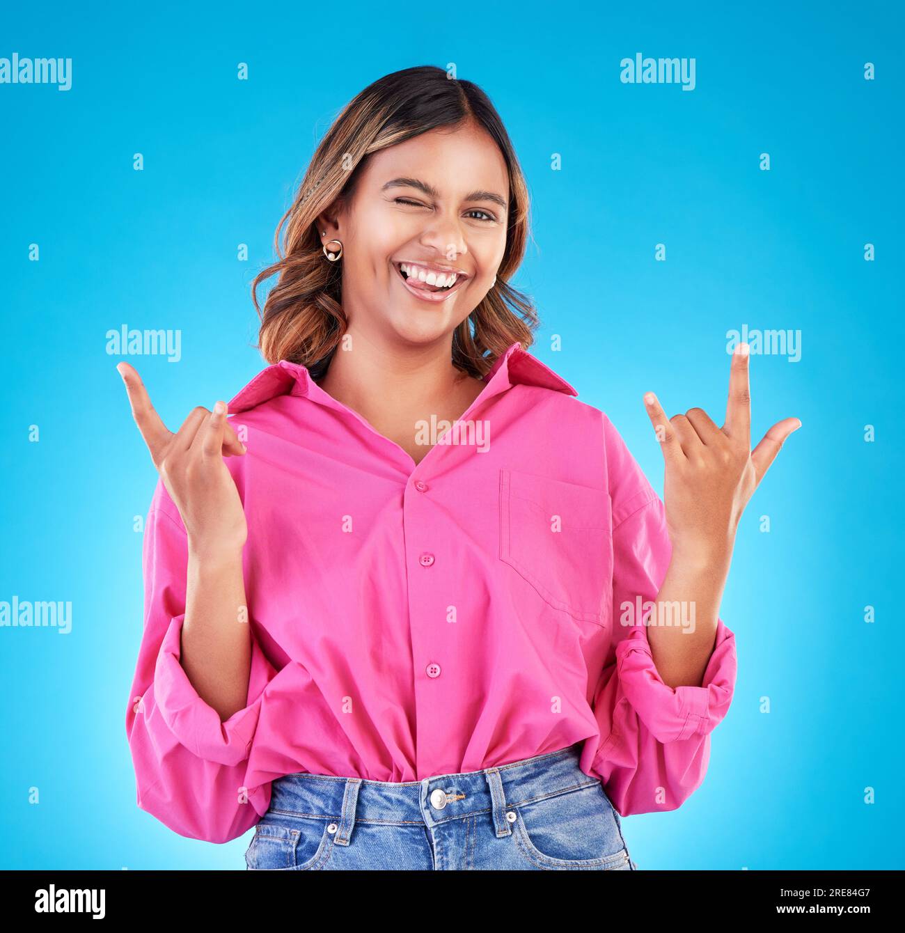 Wink, portrait and woman with rocker hands in studio for freedom, happy ...