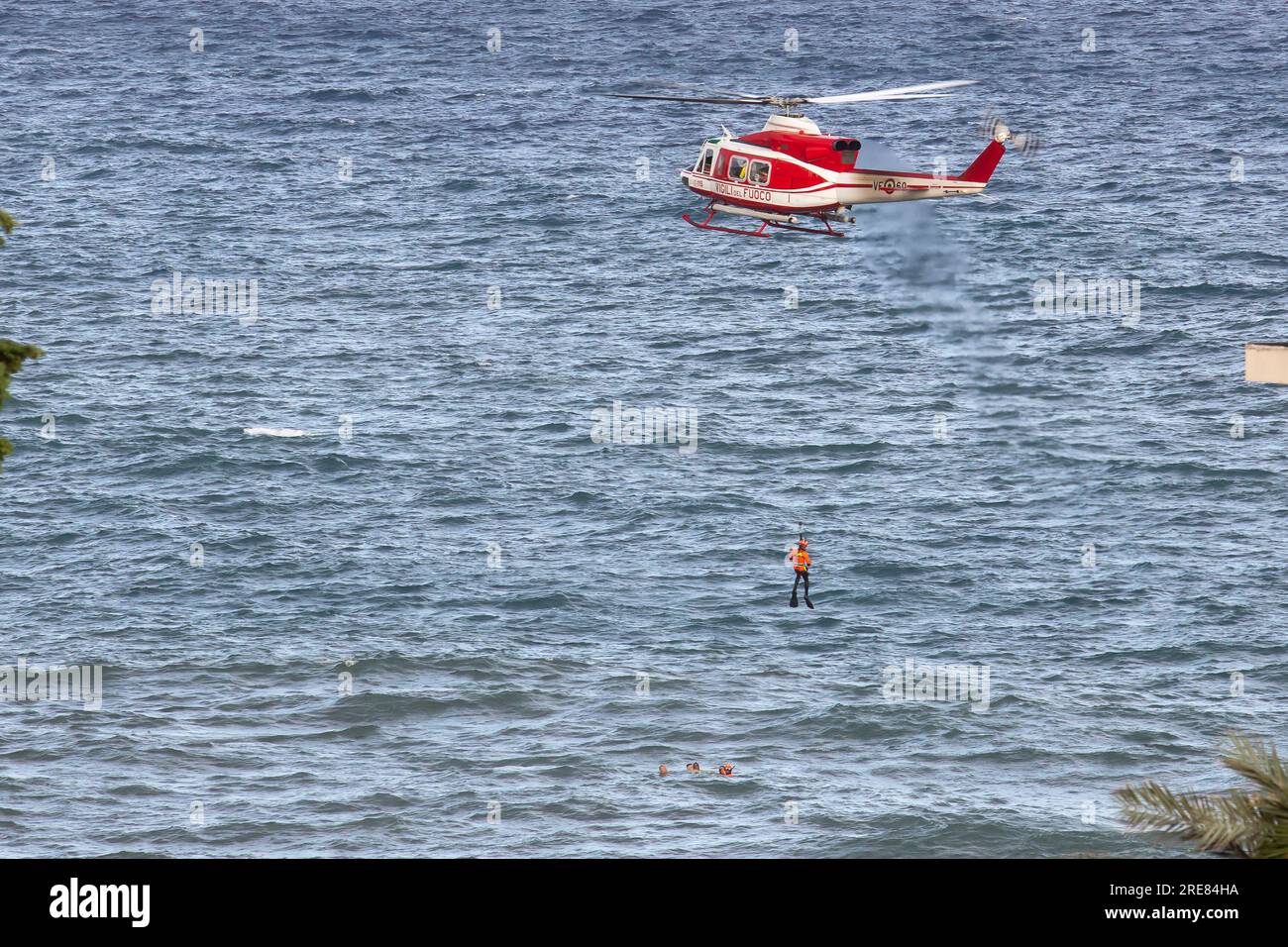 Helicopter rescue swimmers of Vigili del Fuoco assist a group of ...