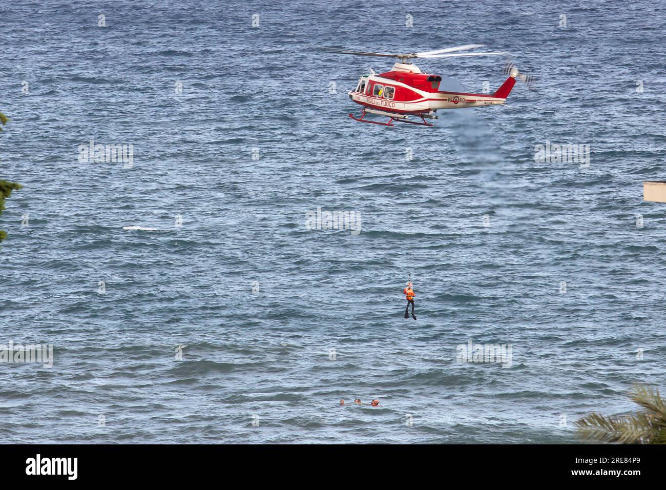 Helicopter rescue swimmers of Vigili del Fuoco assist a group of ...