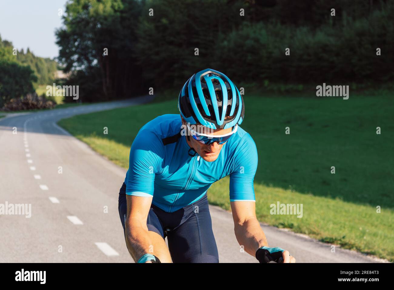 Male professional road cyclist during a race with mad and exhausted ...