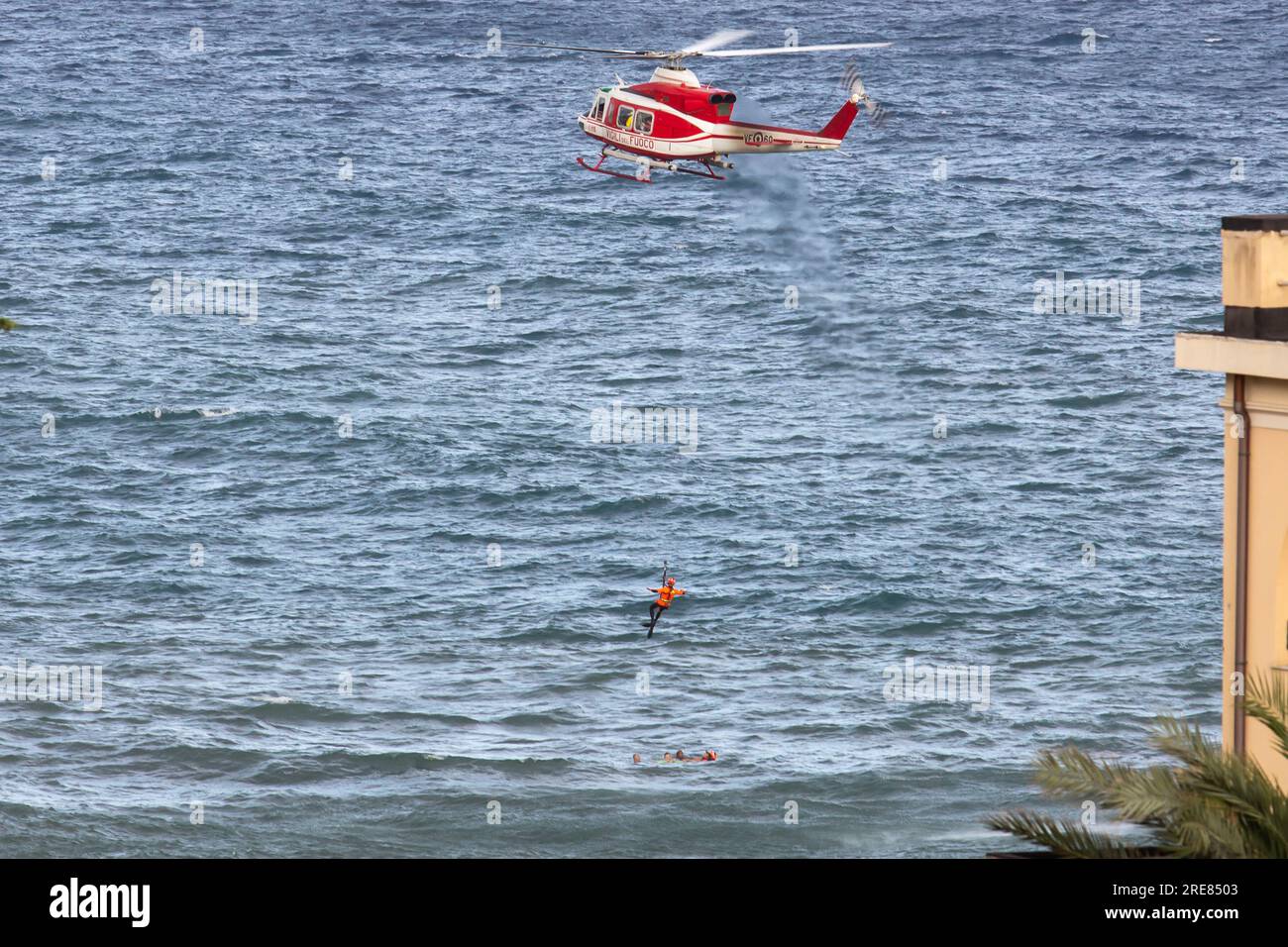 Helicopter rescue swimmers of Vigili del Fuoco assist a group of ...