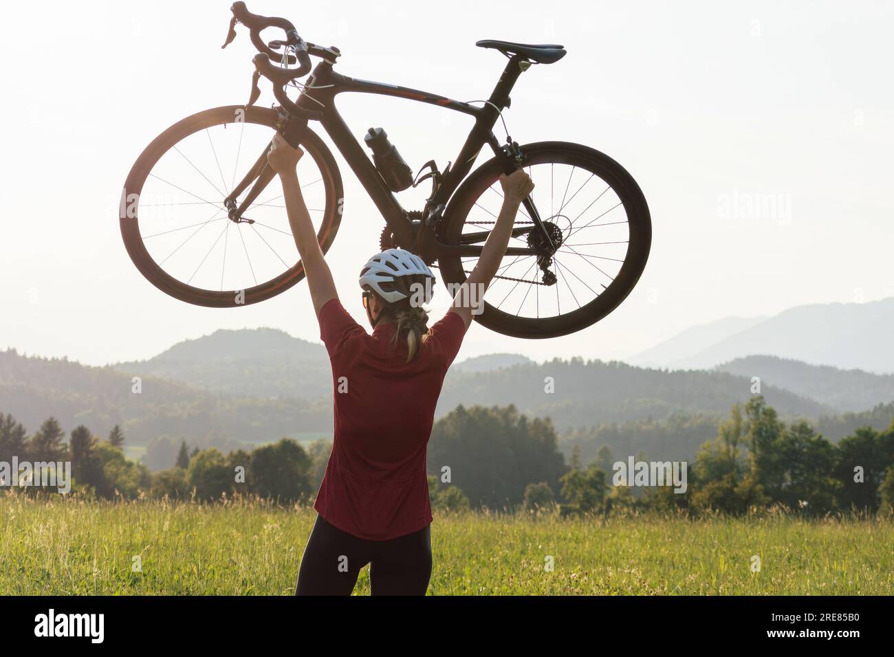 Young female professional bicyclist during road cycling sprint ...