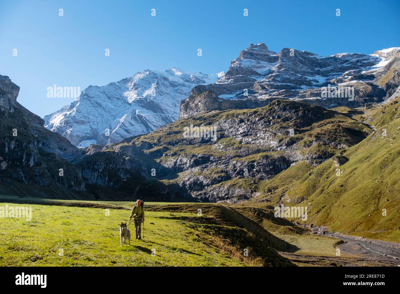 Woman with dog in Switzerland mountain valley Kiental, Berner Oberland ...