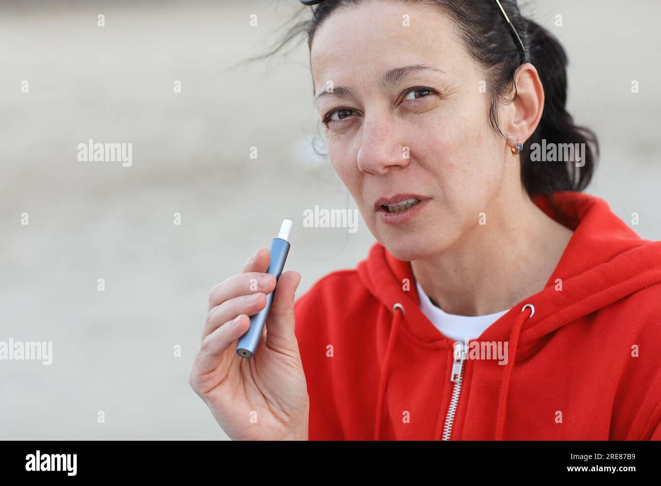 Electronic Cigarette Technology Adult Woman Smokes Hybrid Cigarette Device With Real Tobacco