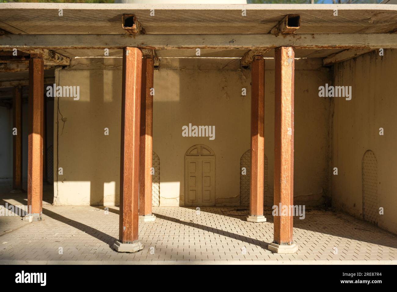 A view of an old mosque with a porch, portico of slender wood columns ...