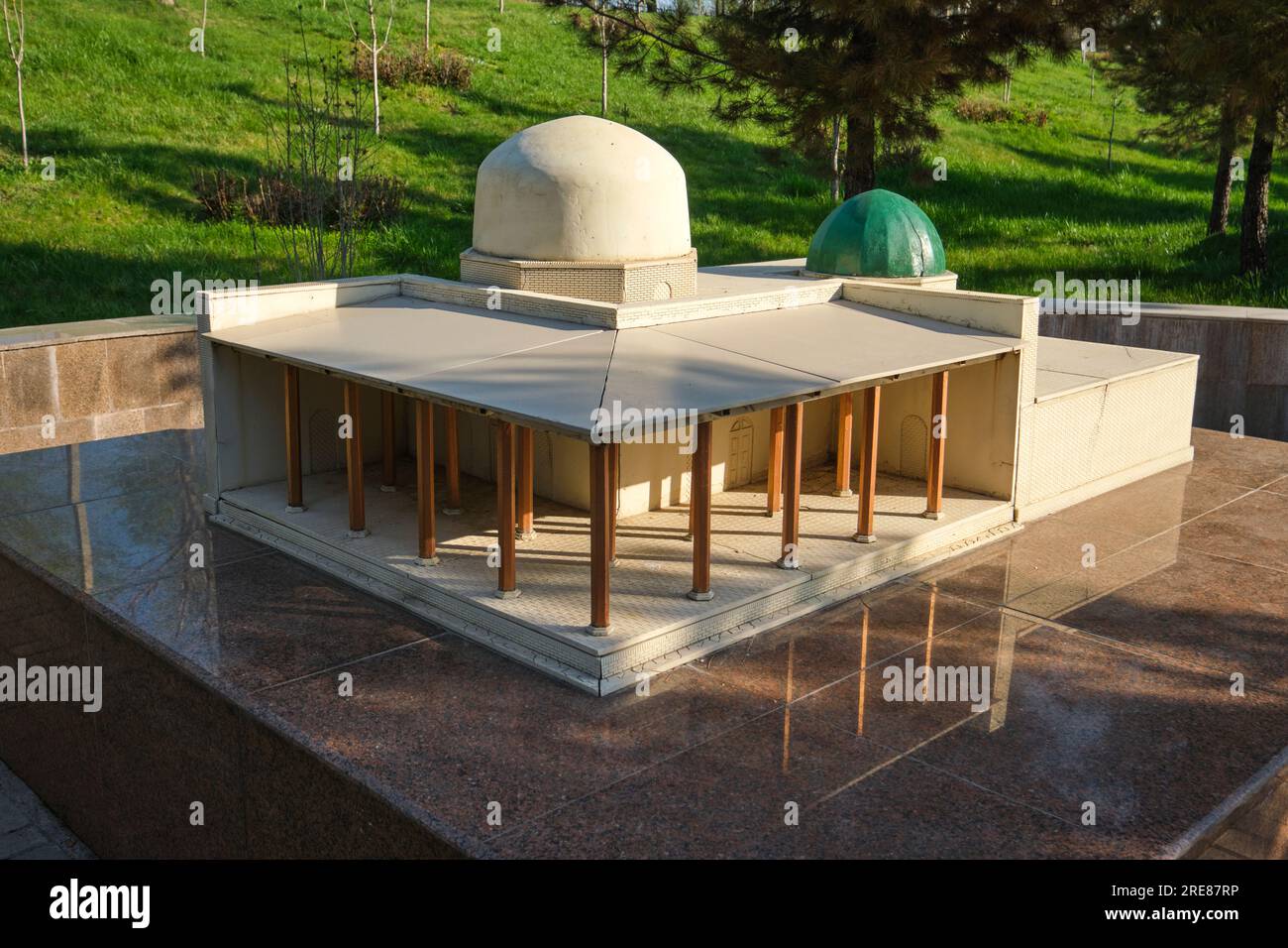 A view of an old mosque with a porch, portico of slender wood columns ...